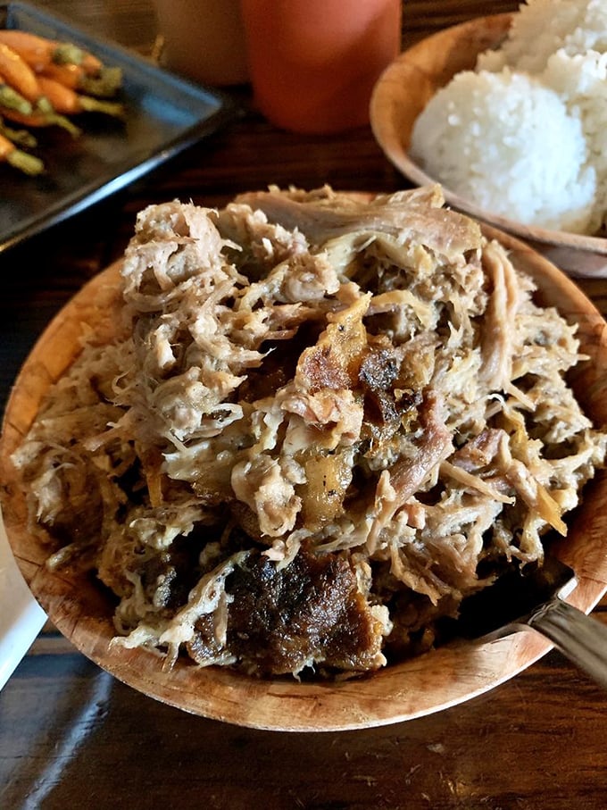 Pulled pork that's had a proper 16-hour slow-roast looks like this—tender strands of smoky goodness that practically fall apart with a stern glance.