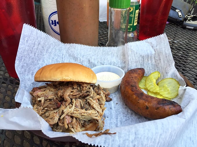 Pulled pork so tender it practically jumped onto that bun voluntarily, with sausage standing guard to ensure you don't leave hungry.