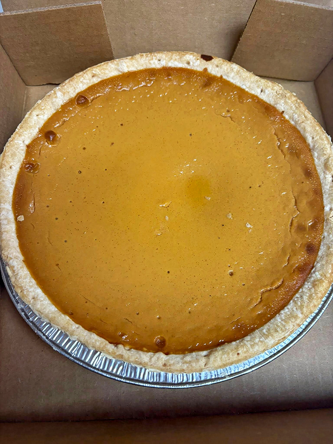 Golden pumpkin pie perfection – the kind that makes you wonder if your grandmother has been secretly moonlighting here.
