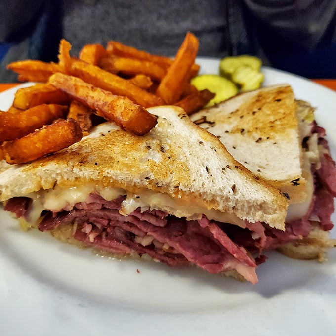 This Reuben isn't just a sandwich—it's architecture. Layers of corned beef and melted cheese creating a savory skyscraper of flavor.