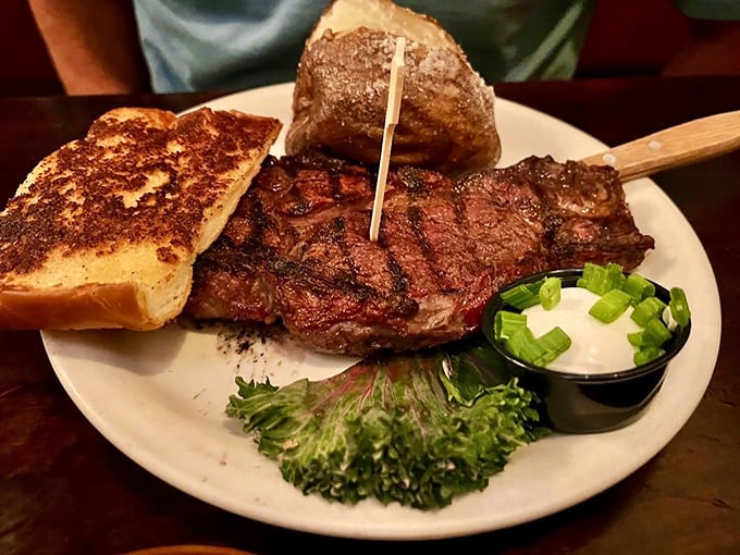 A perfectly charred ribeye that doesn't need a filter—just your undivided attention and maybe that slice of garlic bread for sopping up the juices.