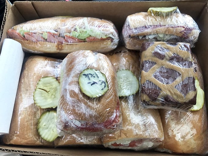 Sandwich architecture at its finest – these wrapped beauties are destined for hungry construction workers, office meetings, and road-tripping families alike.
