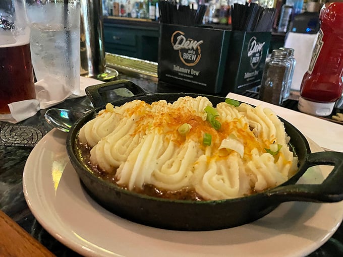 Behold the crown jewel—shepherd's pie served in a cast iron skillet, its potato peaks bronzed to perfection, hiding treasures beneath.