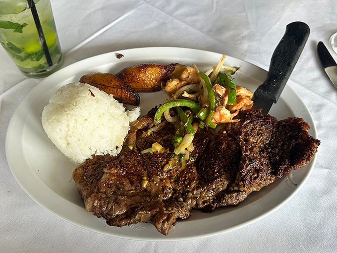 Behold the legendary skirt steak in its natural habitat—perfectly charred, accompanied by white rice and sweet plantains. This is what food dreams are made of.