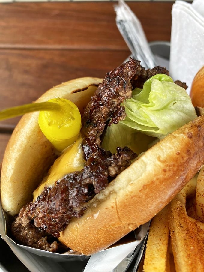 Behold the smash burger in its natural glory—crispy-edged patty, melty cheese, and a brioche bun that somehow manages to contain all that magnificence.