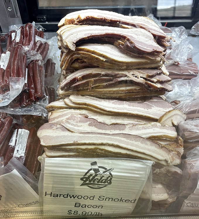 Bacon stacked like gold bars in Fort Knox. This hardwood-smoked treasure makes grocery store versions look like sad imitations.