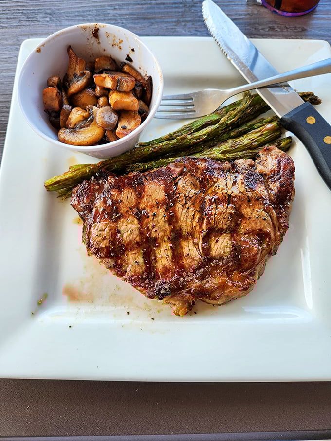 This isn't just a steak—it's a masterpiece of meat, perfectly seared and accompanied by grilled asparagus and sautéed mushrooms that could steal the show on their own.