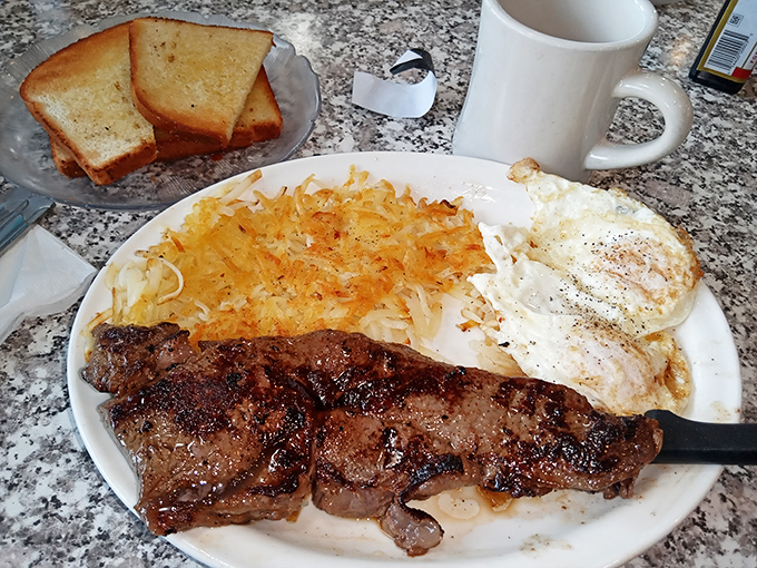 This isn't just steak and eggs—it's breakfast manifest destiny. Golden hash browns and perfectly cooked eggs complete this morning masterpiece.