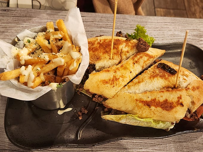 This steak sandwich isn't just a meal, it's an event – complete with perfectly seasoned fries that deserve their own spotlight.