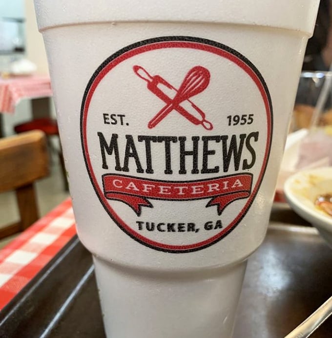 That's not just any styrofoam cup—it's a vessel of sweet tea magic, proudly displaying the Matthews logo like a badge of Southern honor.