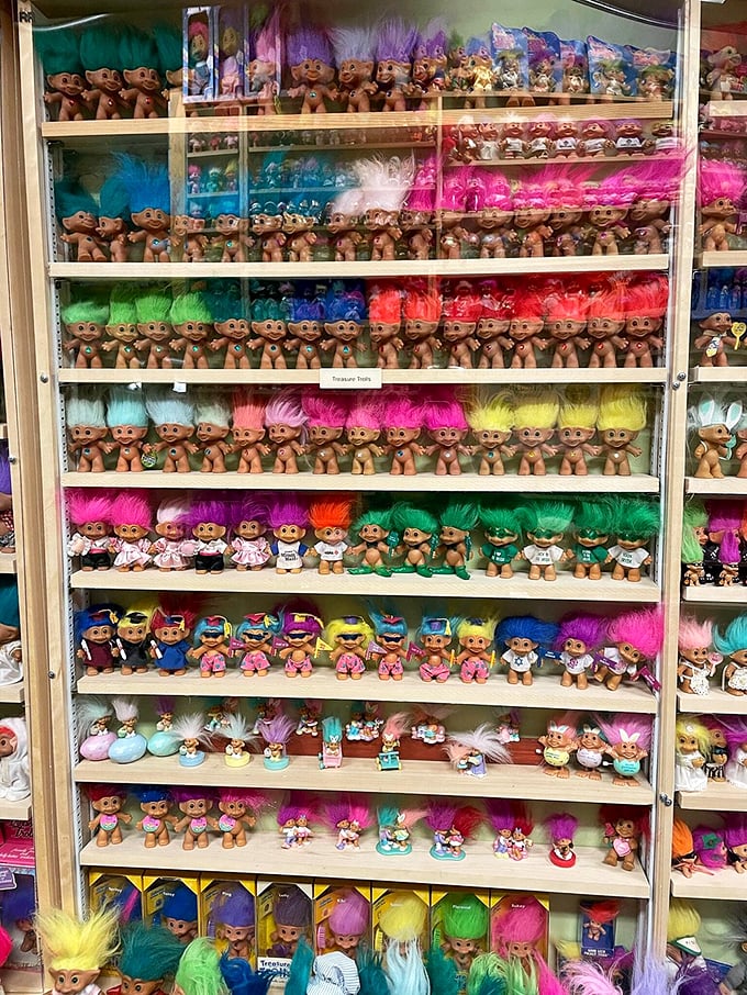 Rows upon rows of perfectly organized trolls create a rainbow army of perpetual joy.