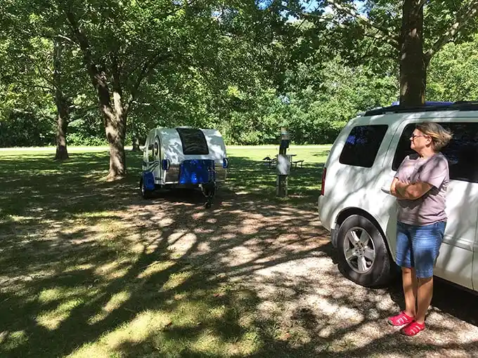 Camping done right – a teardrop trailer nestled among trees that have witnessed more family vacations than a station wagon.