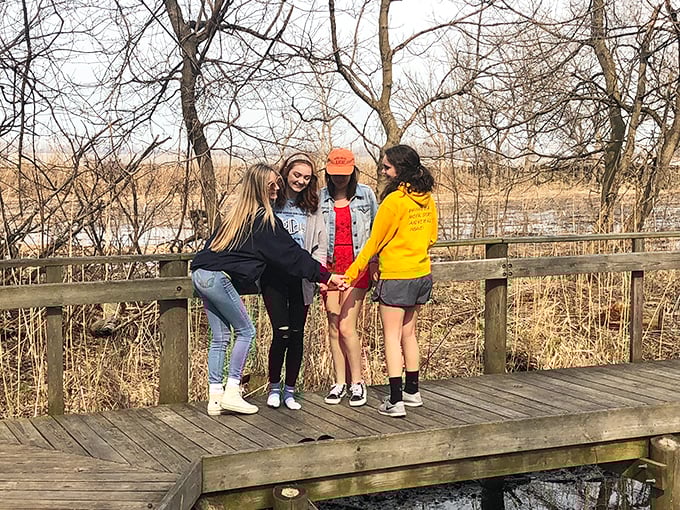 Friends finding joy on the boardwalk observation deck – where memories are made one laugh at a time.