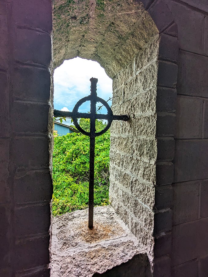 A Celtic cross framed by stone, this window offers more than a view—it's a portal between Florida's sunshine and Ireland's ancient spiritual traditions.