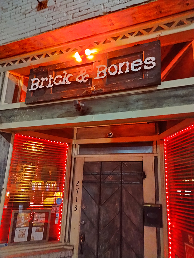 Brick & Bones entrance: That weathered door isn't keeping secrets—it's protecting some of Dallas' most crave-worthy chicken until you arrive.