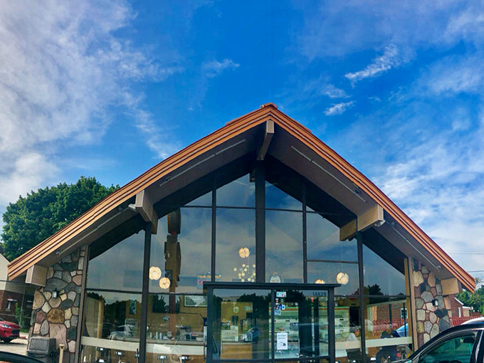 Modern glass and stone architecture housing old-fashioned donut magic – sometimes the best combinations come from unexpected contrasts.