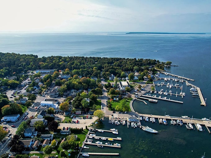 Aerial views reveal Fish Creek's perfect harbor where boats rest easy and time slows to a gentle drift.