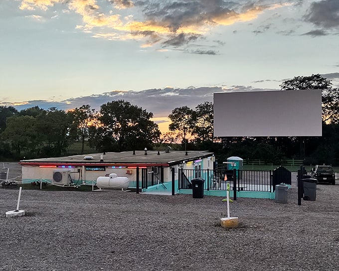 The massive screen dominates the landscape like a friendly giant welcoming movie lovers home.