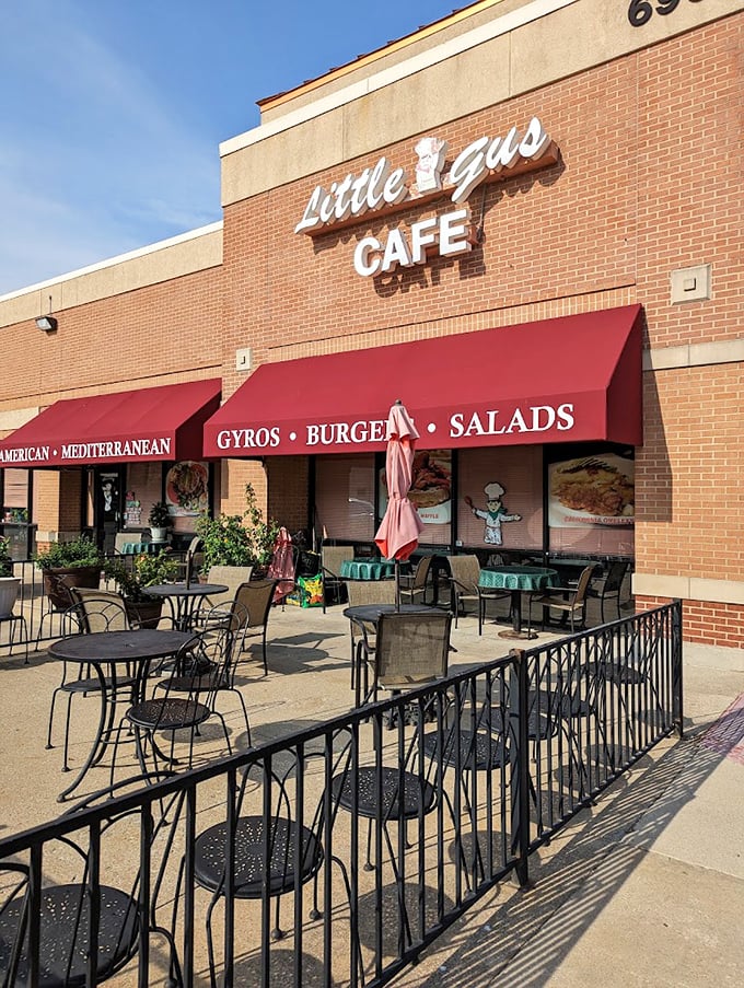 Little Gus Cafe's brick facade and red awning create an inviting Mediterranean-American fusion experience.