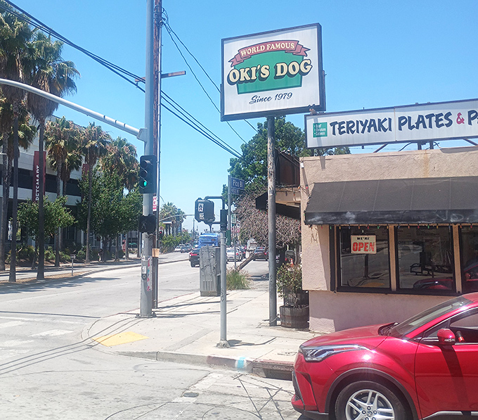 Don't judge this weathered corner spot by its faded sign – inside lies decades of hot dog perfection.
