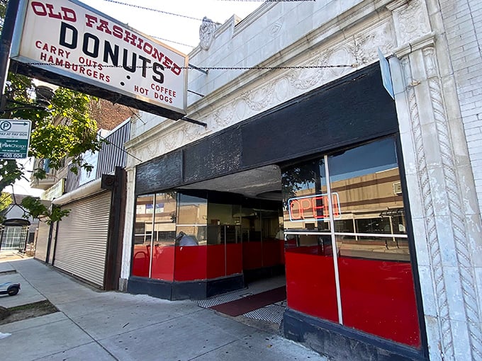 That classic red and black storefront whispers decades of donut wisdom to anyone who'll listen.
