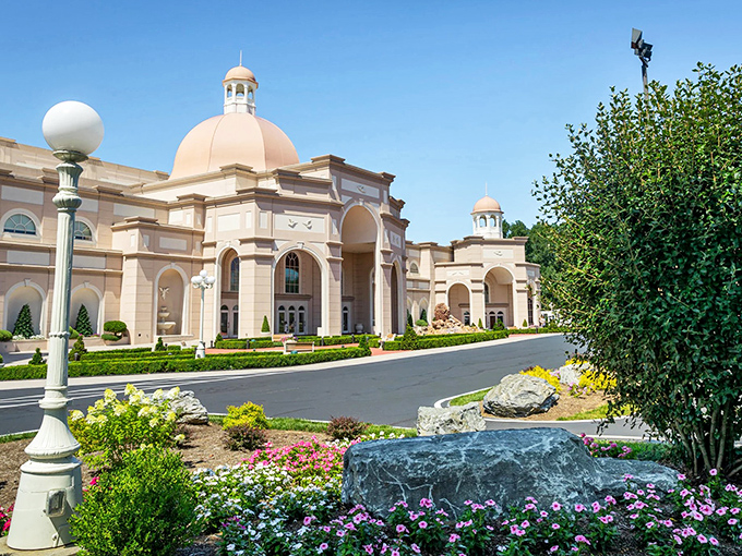 Ronks' unexpected palace! Like finding a wedding cake in a field of muffins—this ornate structure dazzles against its garden backdrop.