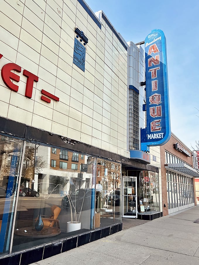 That blue neon "ANTIQUE" sign isn't just advertising—it's a beacon for design lovers seeking mid-century modern magic.