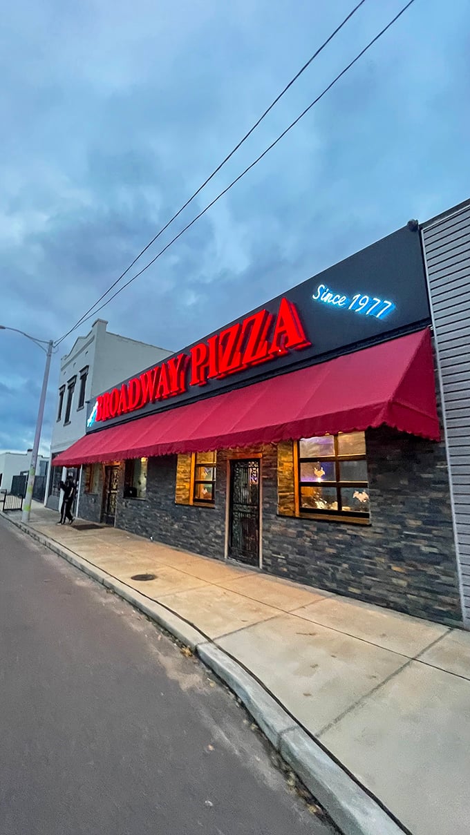 As dusk falls, Broadway Pizza's neon sign becomes a beacon. Generations of Memphians have followed this light to pizza paradise.