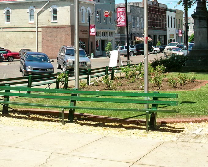 Park benches overlook Corinth's bustling intersection - the perfect spot for people-watching and budget-stretching contemplation.