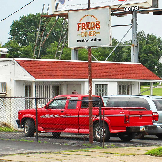 Behind that chain-link fence and simple white exterior, Fred's Diner serves up "Breakfast Anytime"—words more beautiful than any poetry to a hungry traveler.