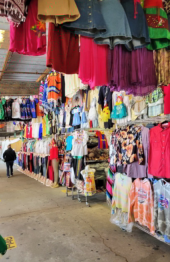 Clothing displays create a textile jungle where fashion treasures hide in plain sight. The thrill of the hunt is real!