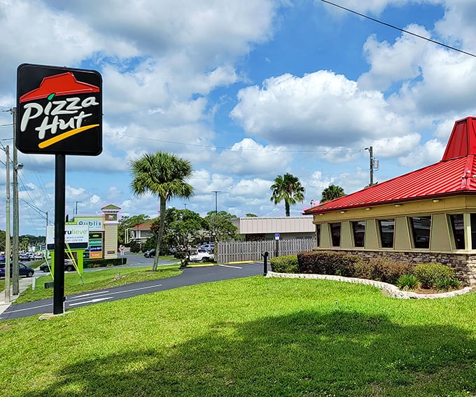 Even Pizza Hut gets the tropical treatment in Inverness—that iconic red roof practically winking at palm trees like old friends.