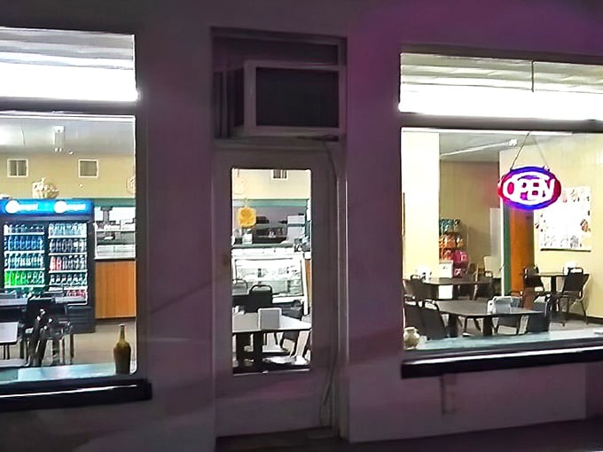 Peek through these windows and glimpse pizza paradise – where fluorescent lights illuminate deliciousness waiting to happen.