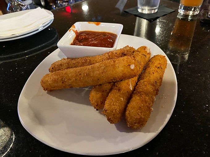 Mozzarella sticks that actually snap when you bite them! Crispy exterior, molten interior, and that marinara sauce – a perfect harmony of textures.