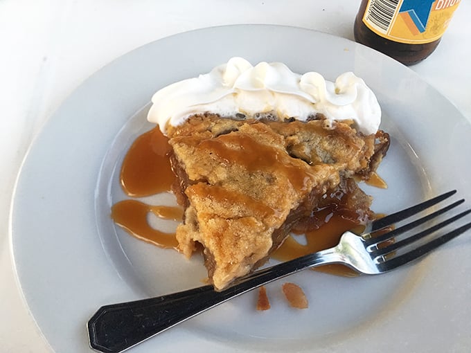 This isn't just apple pie—it's an edible time machine to your grandmother's kitchen, complete with caramel drizzle and whipped cream that refuses to take itself too seriously.