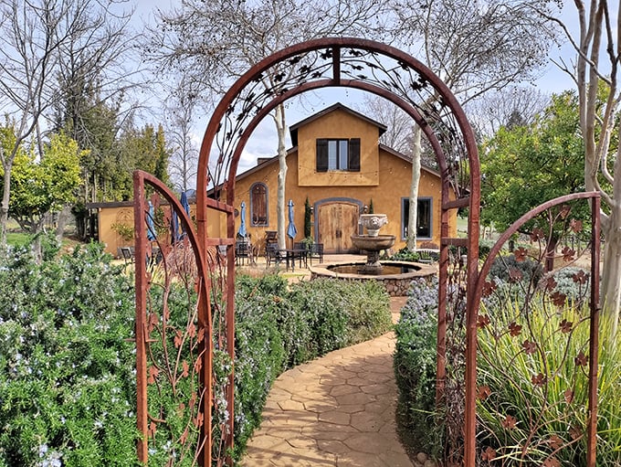 Through this rustic garden archway lies a Mediterranean dream—Avio Vineyards' Tuscan-style tasting room feels like you've been teleported to Italy without the jet lag.