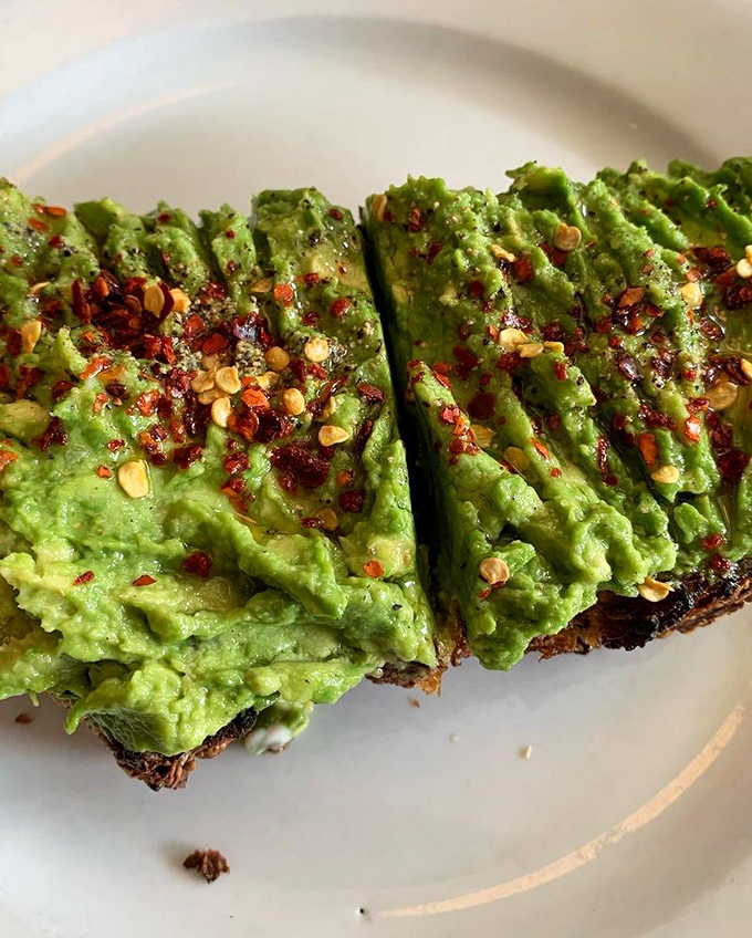 Avocado toast that actually deserves its Instagram fame. Those red pepper flakes aren't just garnish—they're little flavor fireworks.