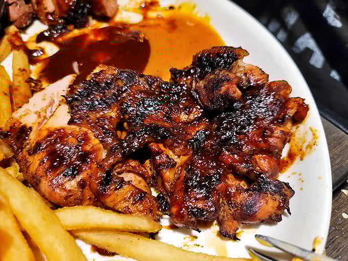 Blackened, beautiful, and beckoning—this brick chicken has clearly graduated with honors from the School of Perfect Char and Juicy Interiors. 