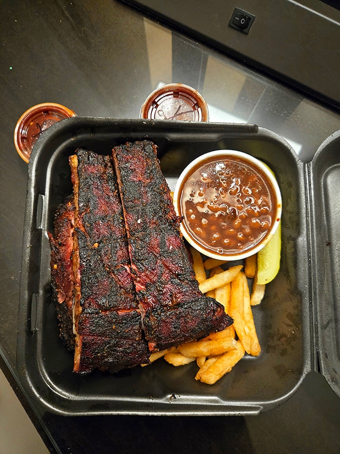 These ribs aren't just falling off the bone—they're practically volunteering to jump onto your plate. Paired with beans and fries, it's comfort food nirvana.