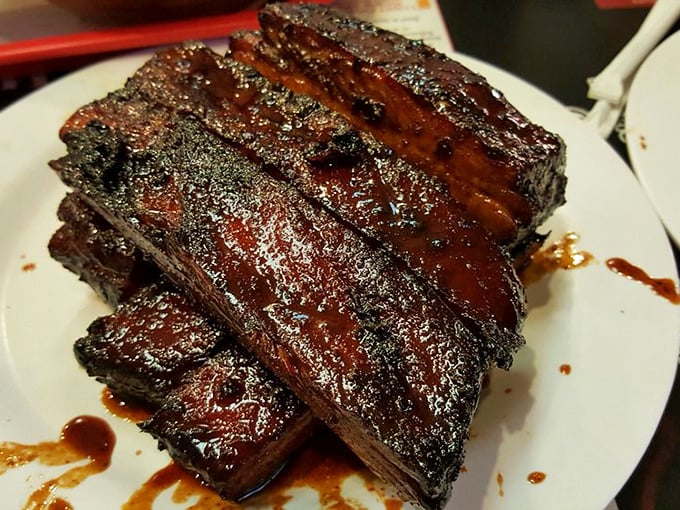 These ribs don't just fall off the bone—they practically leap into your mouth, glistening with sauce and sporting that perfect pink smoke ring.