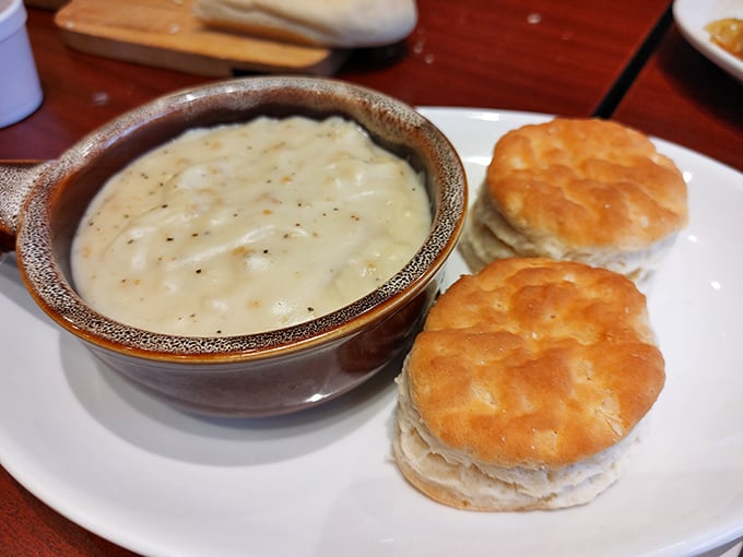 Biscuits and gravy—the cornerstone of any respectable diner breakfast. This ceramic bowl of comfort could cure whatever ails you, no prescription needed.