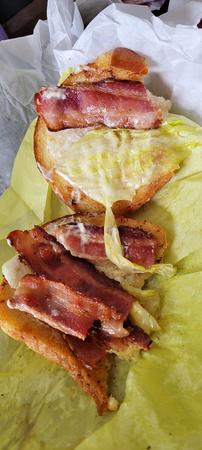 The BLT elevated to art form—where bacon doesn't just participate, it takes center stage in this handheld masterpiece.