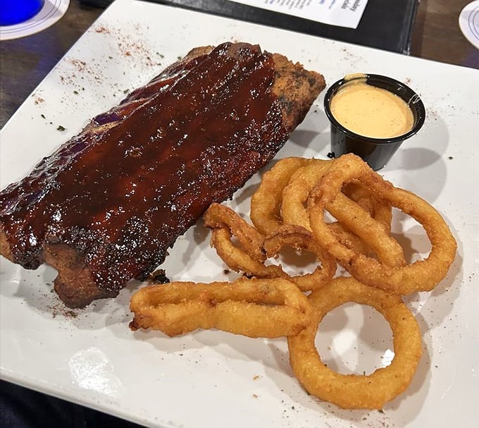 These baby back ribs don't just fall off the bone – they practically leap into your mouth, leaving behind a trail of sticky, sweet evidence on your fingers.