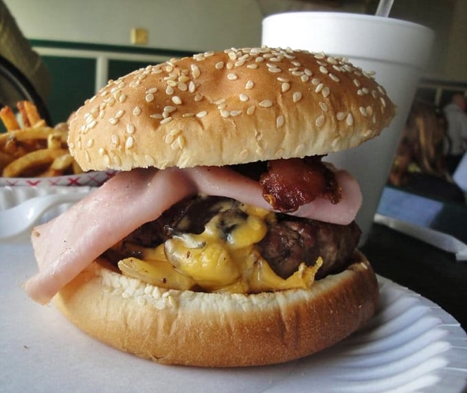 This isn't just a bacon cheeseburger—it's a masterclass in American comfort food, where ham, melted cheese, and beef create a holy trinity of flavor.