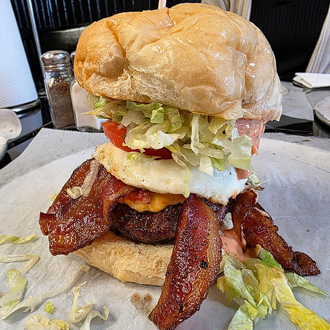 When bacon enters the chat, things get serious. Those crispy strips aren't just toppings – they're the crown jewels of this burger kingdom.