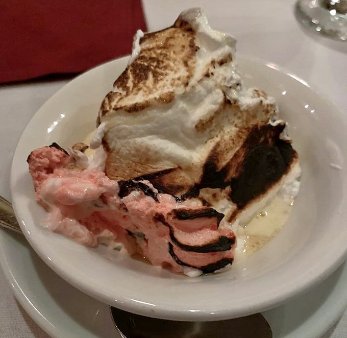 This isn't just dessert, it's architecture with meringue—a baked Alaska that makes you wonder why we don't set more desserts on fire.