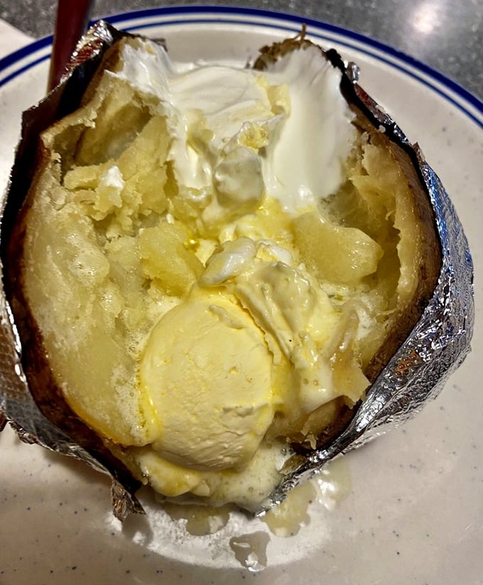 This baked potato isn't just loaded—it's having an identity crisis with all that butter melting into its fluffy innards.