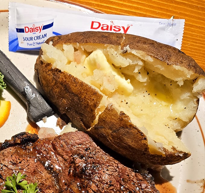 Butter melting into a perfectly fluffed potato interior—a simple pleasure that somehow tastes better in the Ozarks than anywhere else on earth.