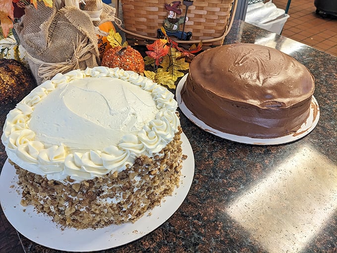 Cake royalty holding court! The banana nut with its crown of cream and the chocolate masterpiece standing guard – dessert democracy at its finest.