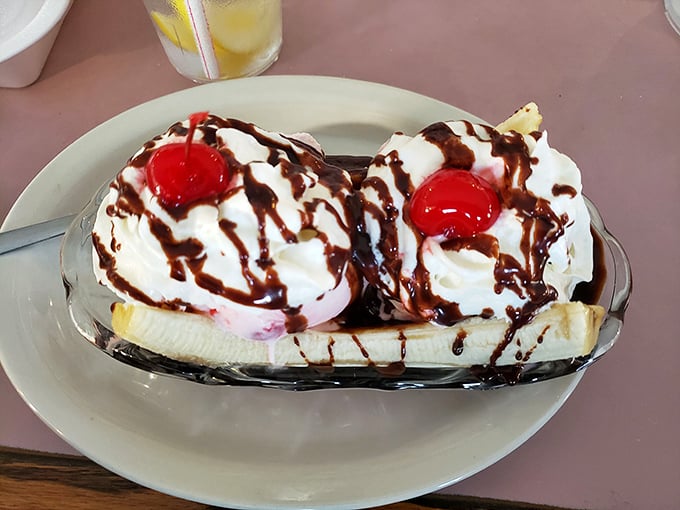 This banana split isn't just dessert—it's architecture, sculpture, and pure joy served in a boat that's setting sail for your happiest childhood memories.